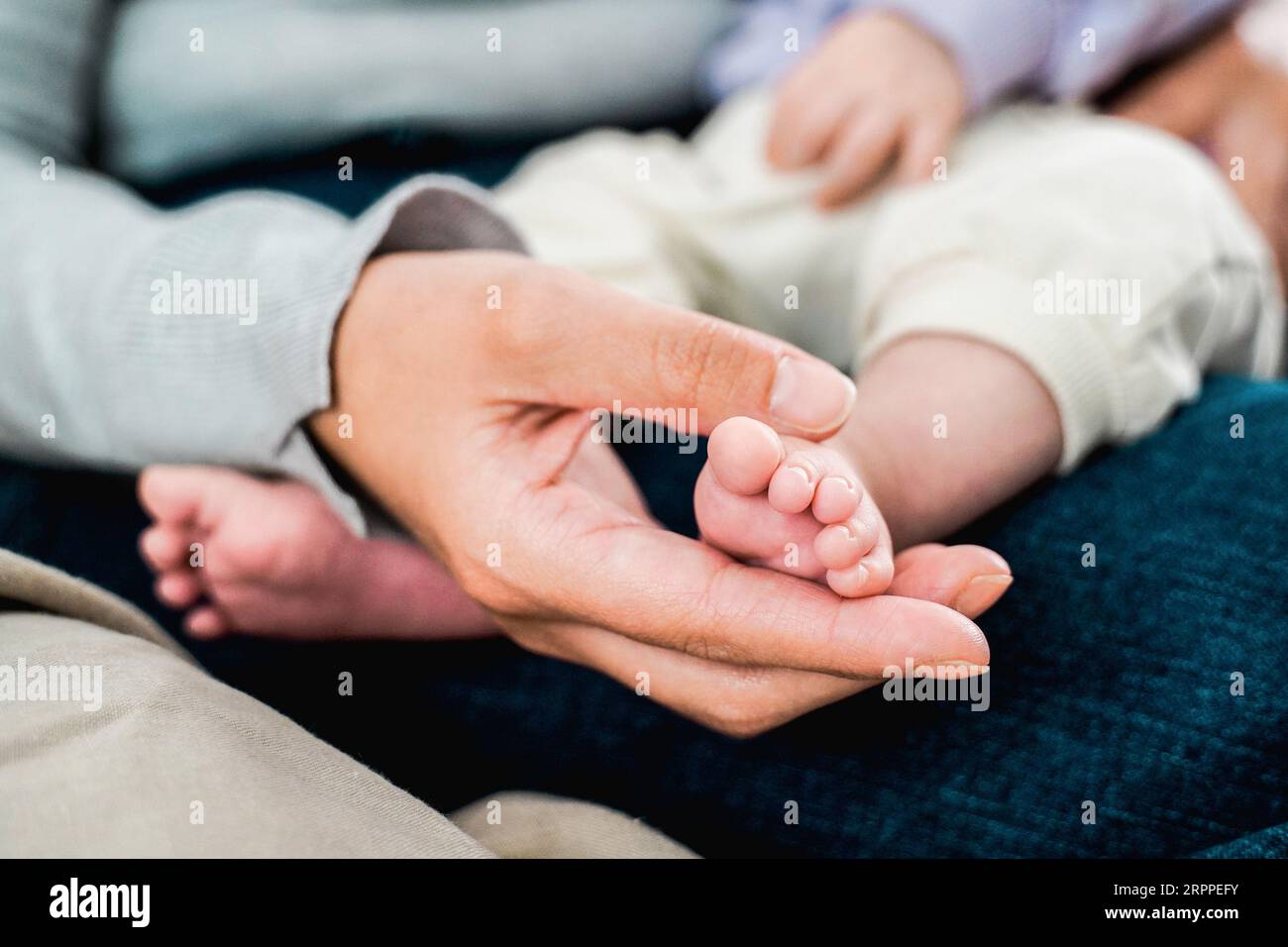 Newborn baby and mother hold infant feet - Family mum and son ...