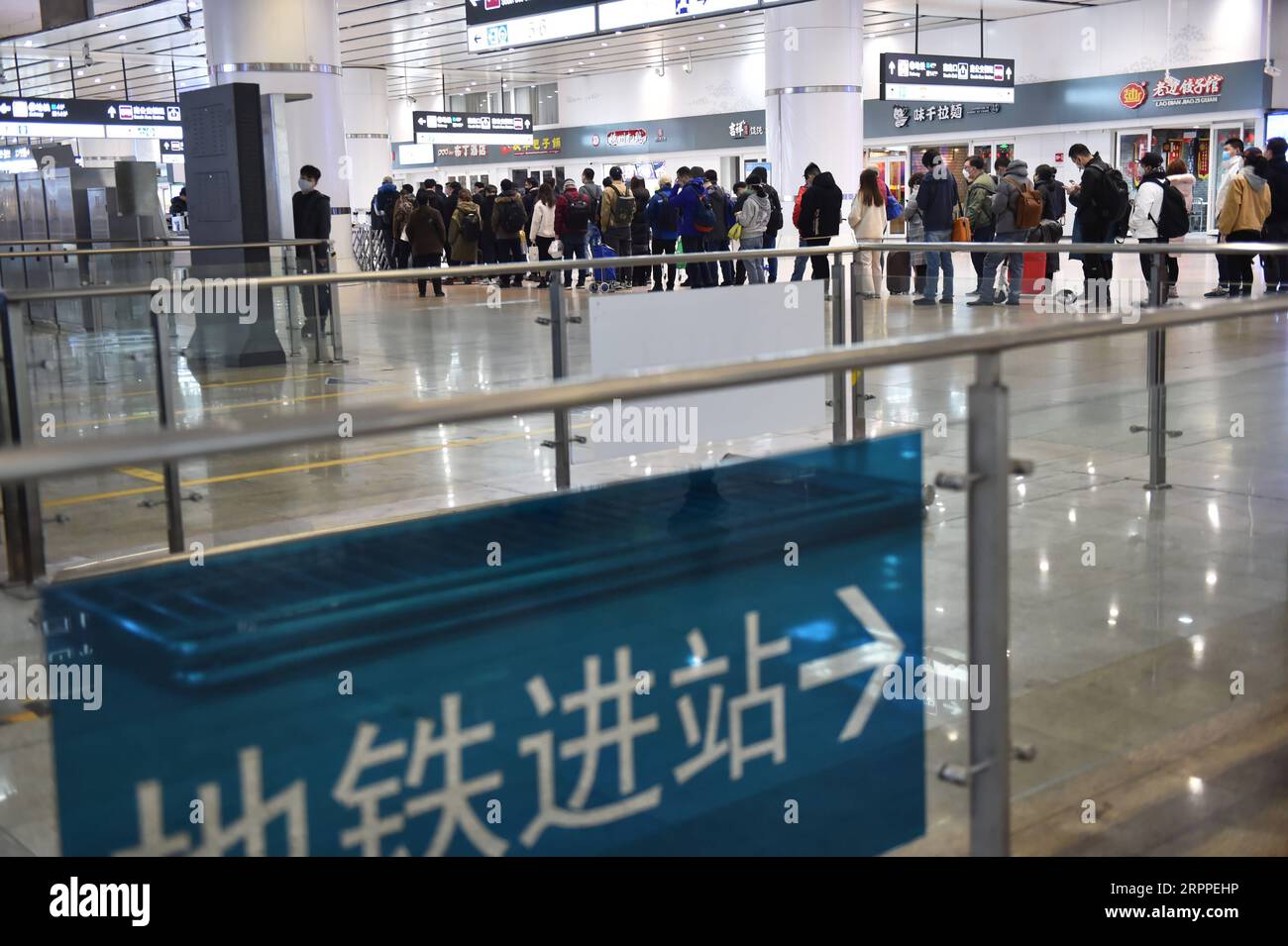 200316 -- BEIJING, March 16, 2020 -- Passengers line up to enter a ...
