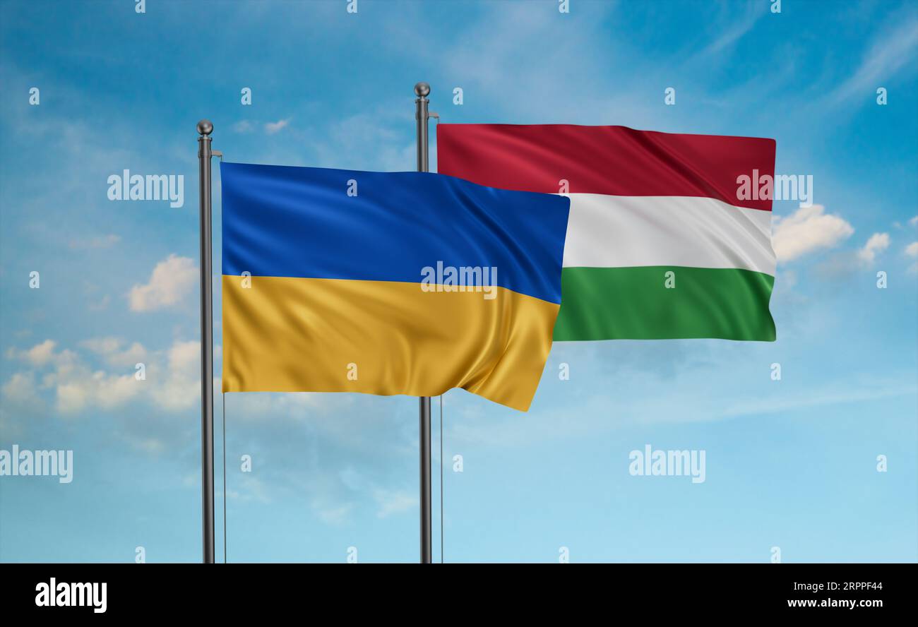 Hungary flag and Ukraine flag waving together on blue sky, two country ...