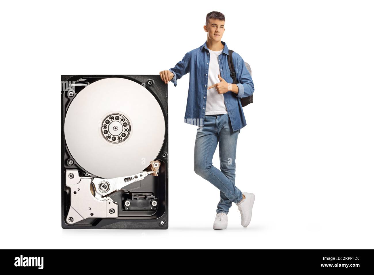 Guy with a backpack leaning and pointing on a hard disk isolated on ...