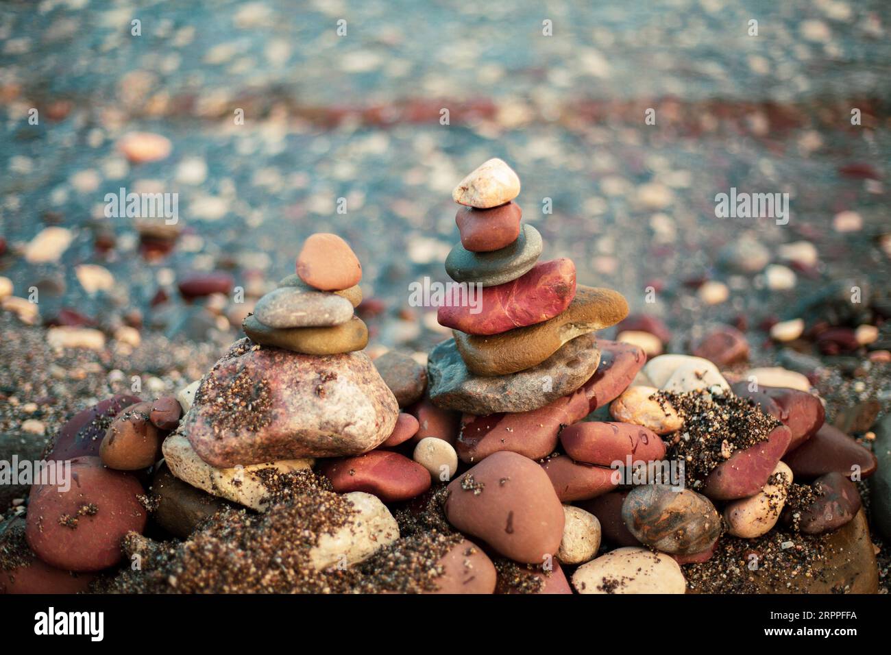 Stack of round smooth stones by the sea Stock Photo - Alamy