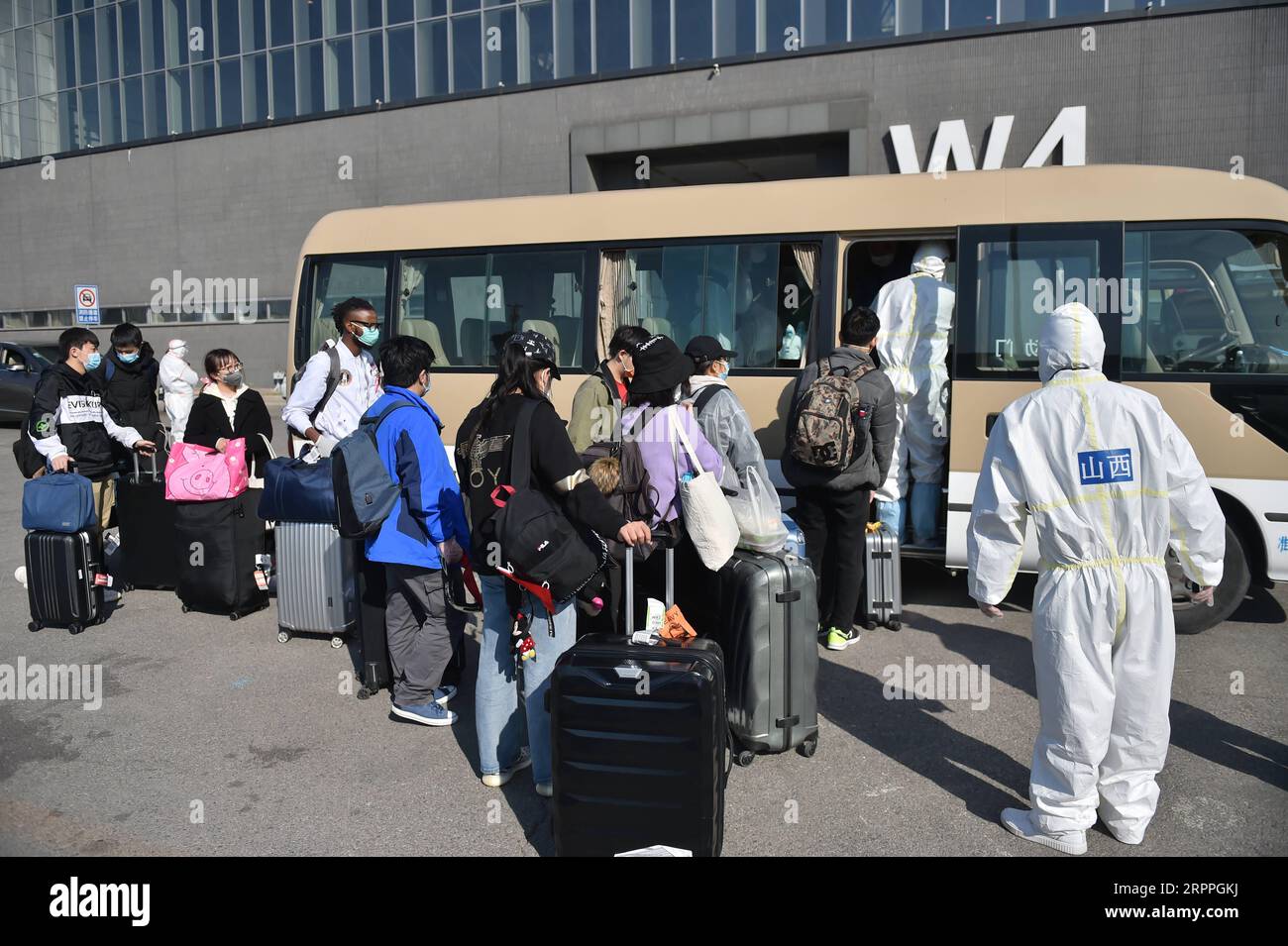 200317 -- BEIJING, March 17, 2020 -- Inbound passengers board a ...