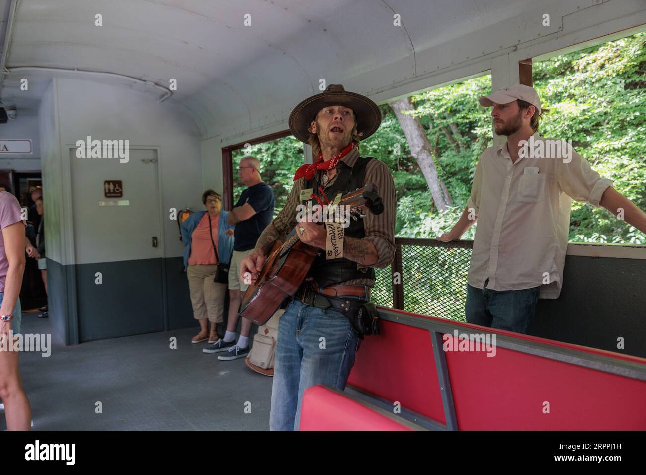 Singer and entertainer singing songs to the passengers for tips on the ...