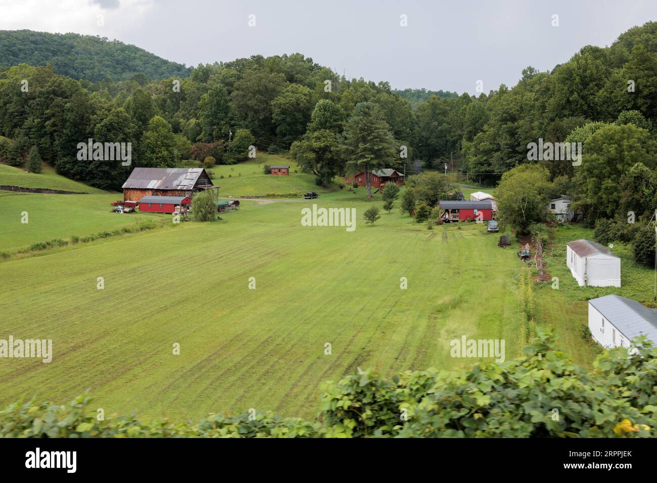Small family farm in the mountains seen from the open air car of the ...