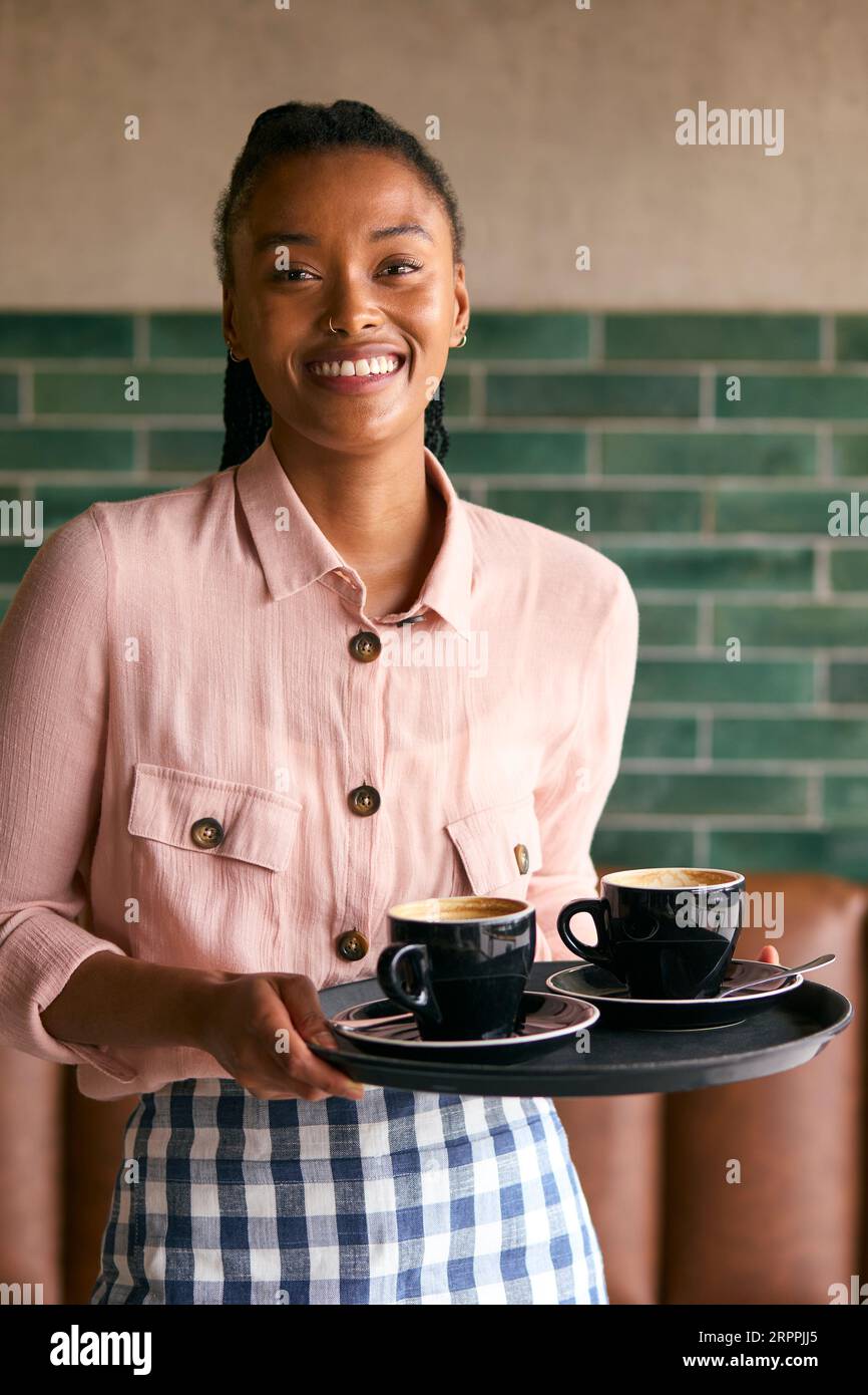 Young café staff carrying hi-res stock photography and images - Alamy