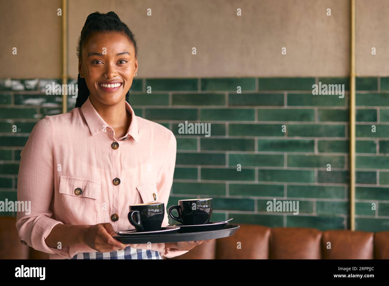 Portrait Of Smiling Female Owner Or Staff Member Carrying Cups In Cafe ...