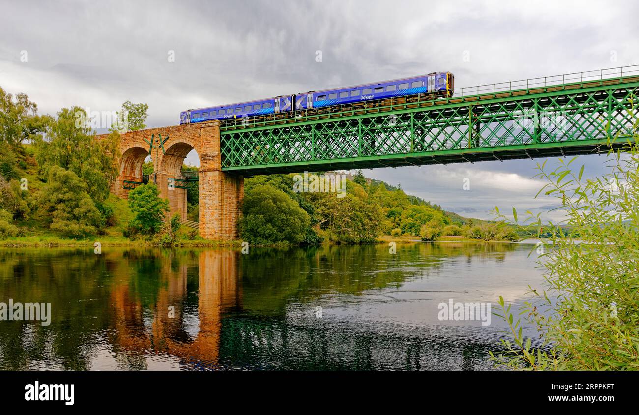 Kyle of Sutherland Scotland a blue ScotRail train crossing the Oykel or ...