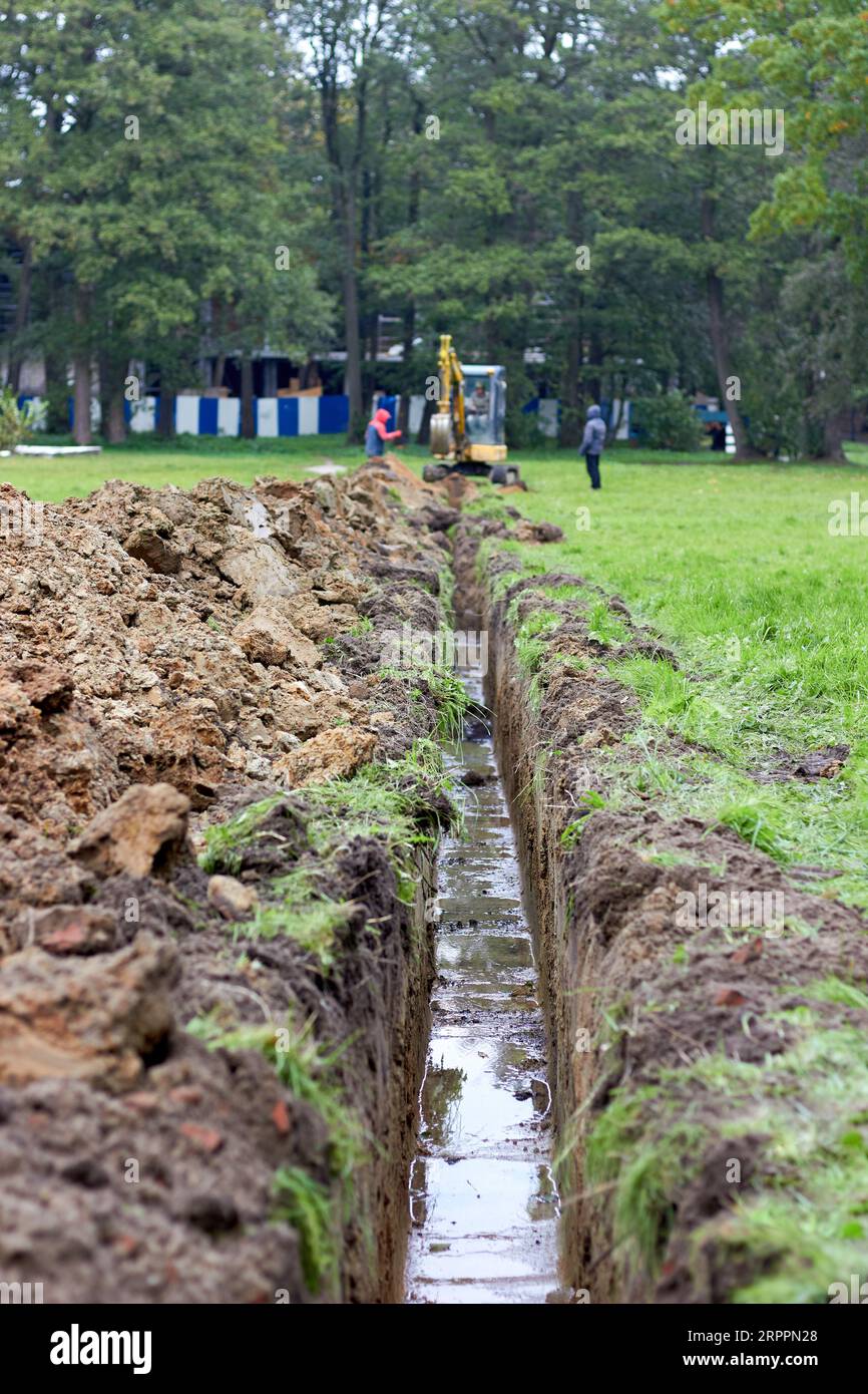 Earthwork construction work using a mini excavator technique. Trench ...