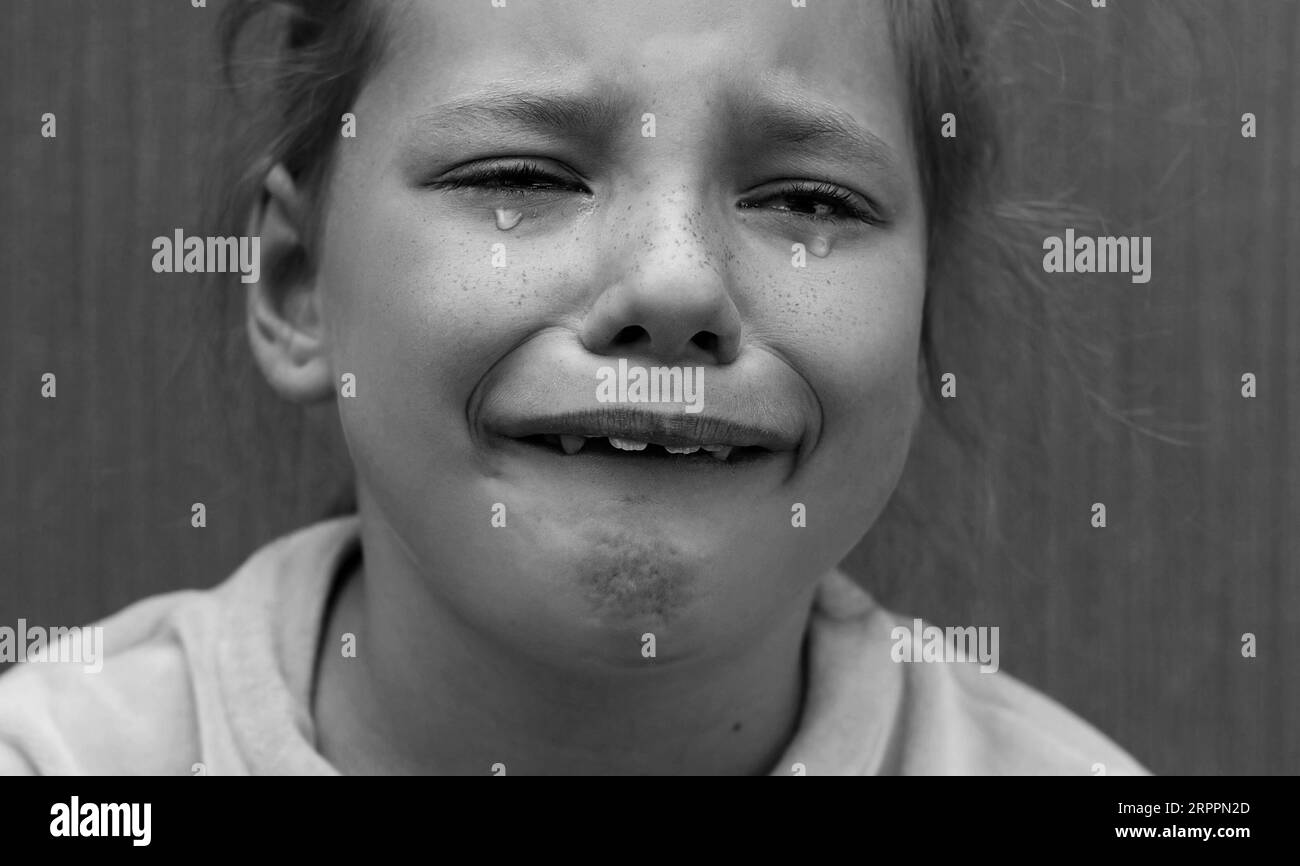 Dramatic photo of a crying kid Stock Photo - Alamy