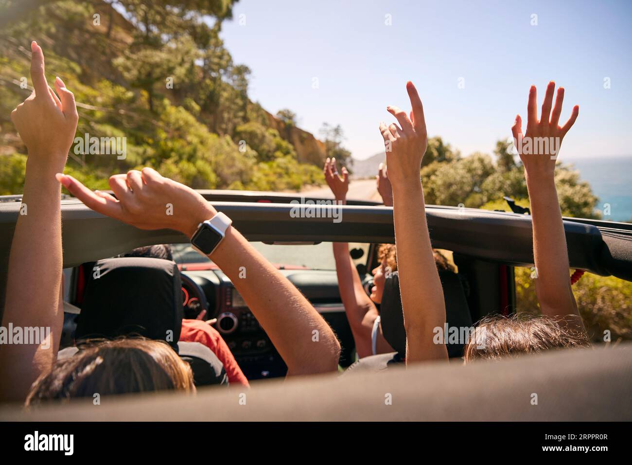 Group Of Laughing Female Friends Putting Hands Through Sunroof Open Top ...