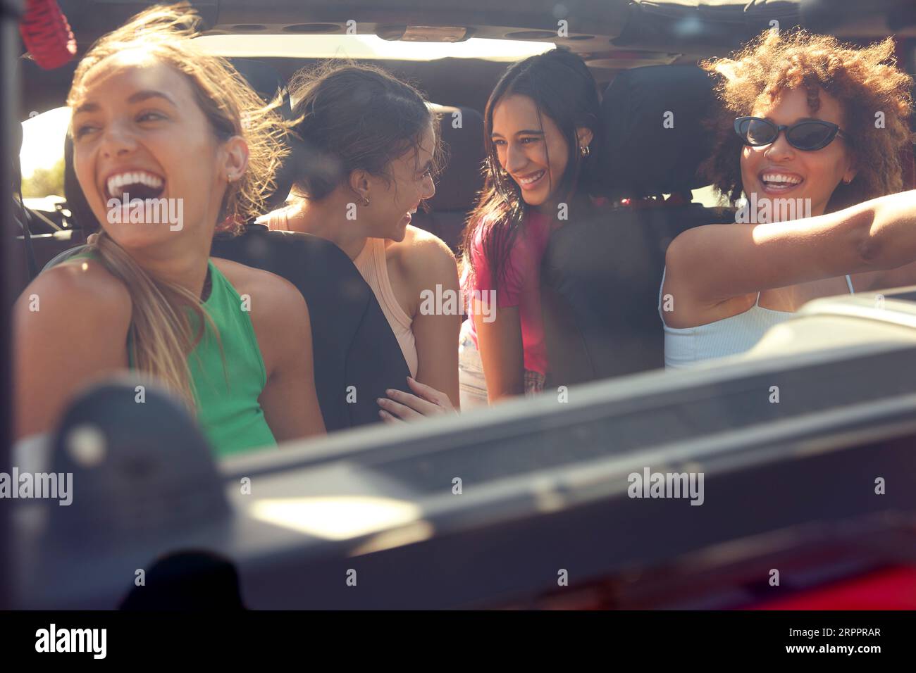 View Through Windscreen Of Group Of Laughing Female Friends Having Fun ...