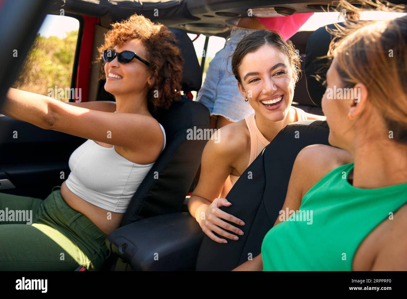 Four friends driving in open top car hi-res stock photography and ...
