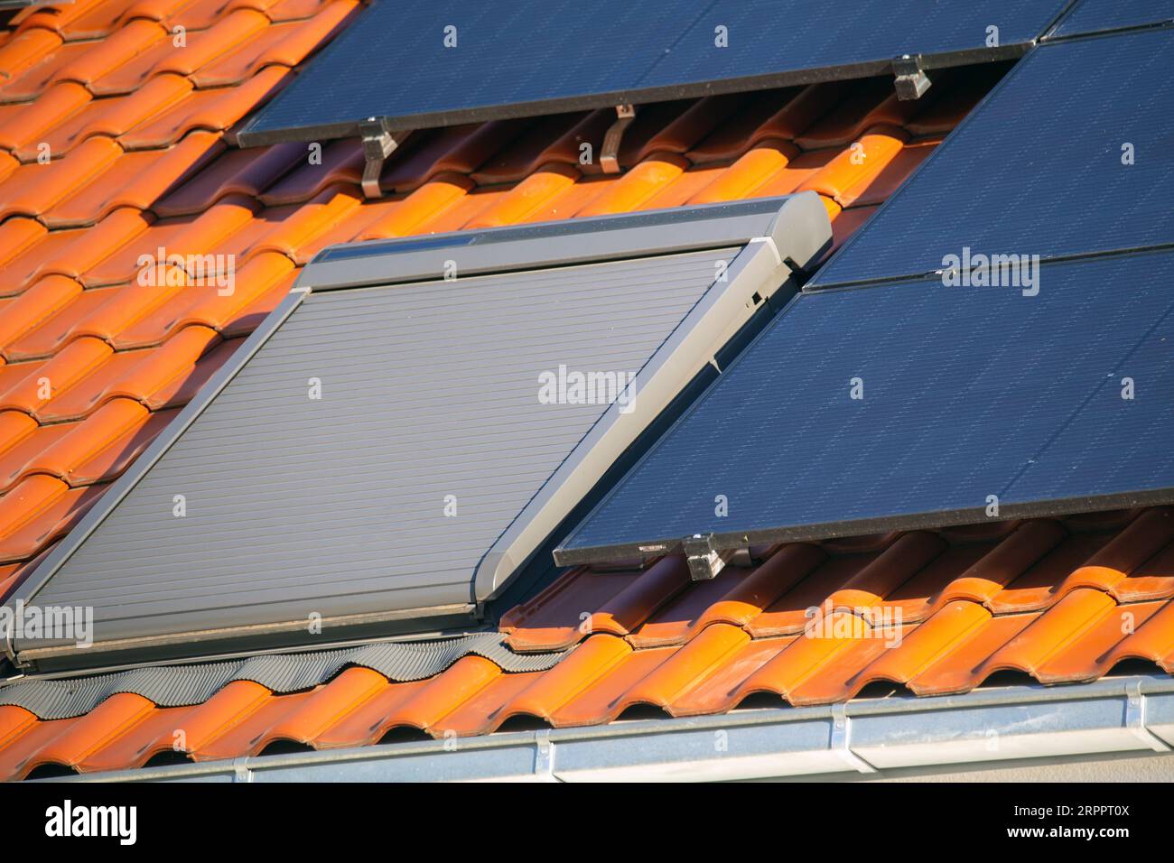 Skylight with roller shutter, next to it panels for solar thermal ...