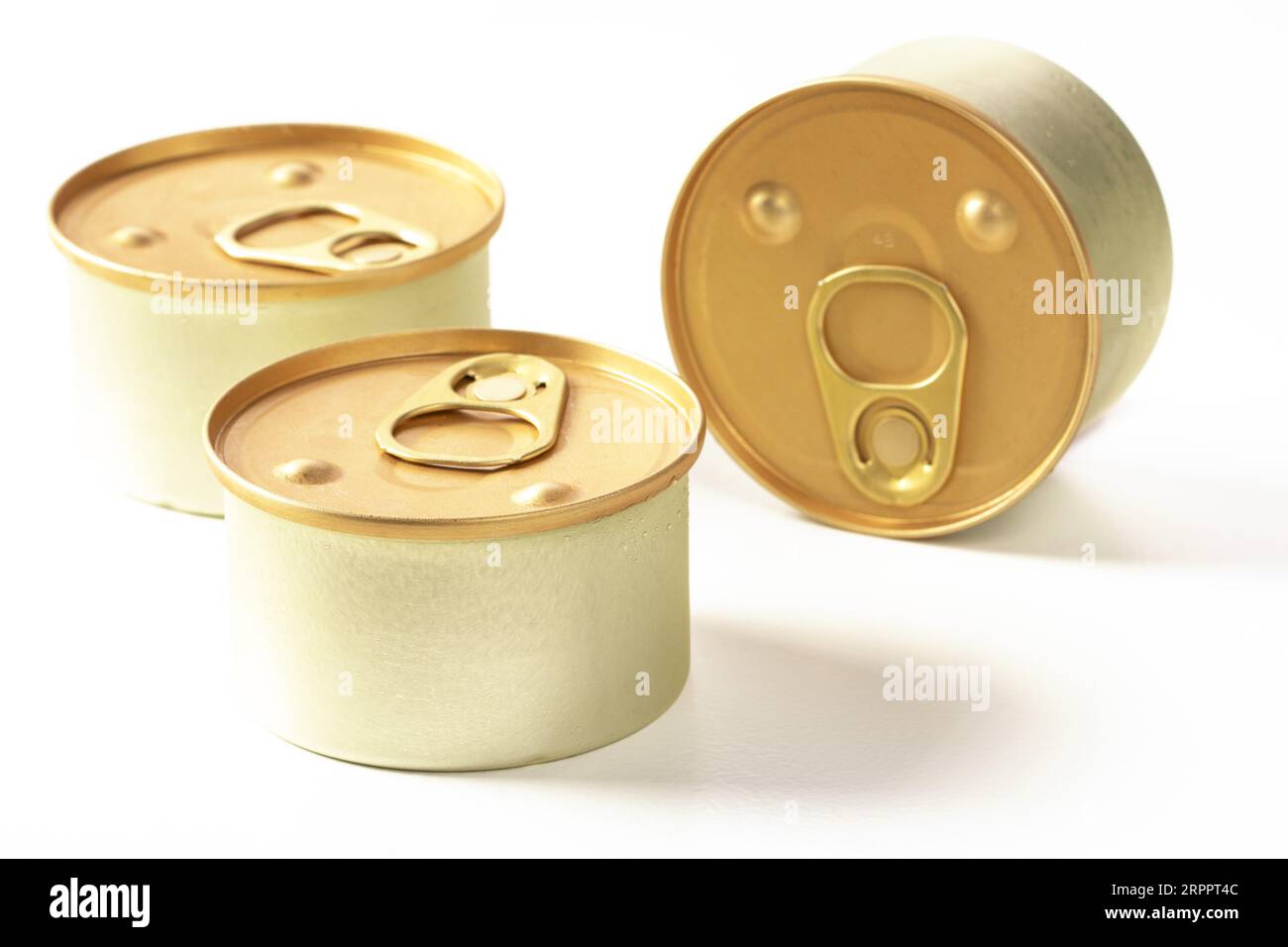 Three metal cans of cat food on a white background. Drops of condensate ...
