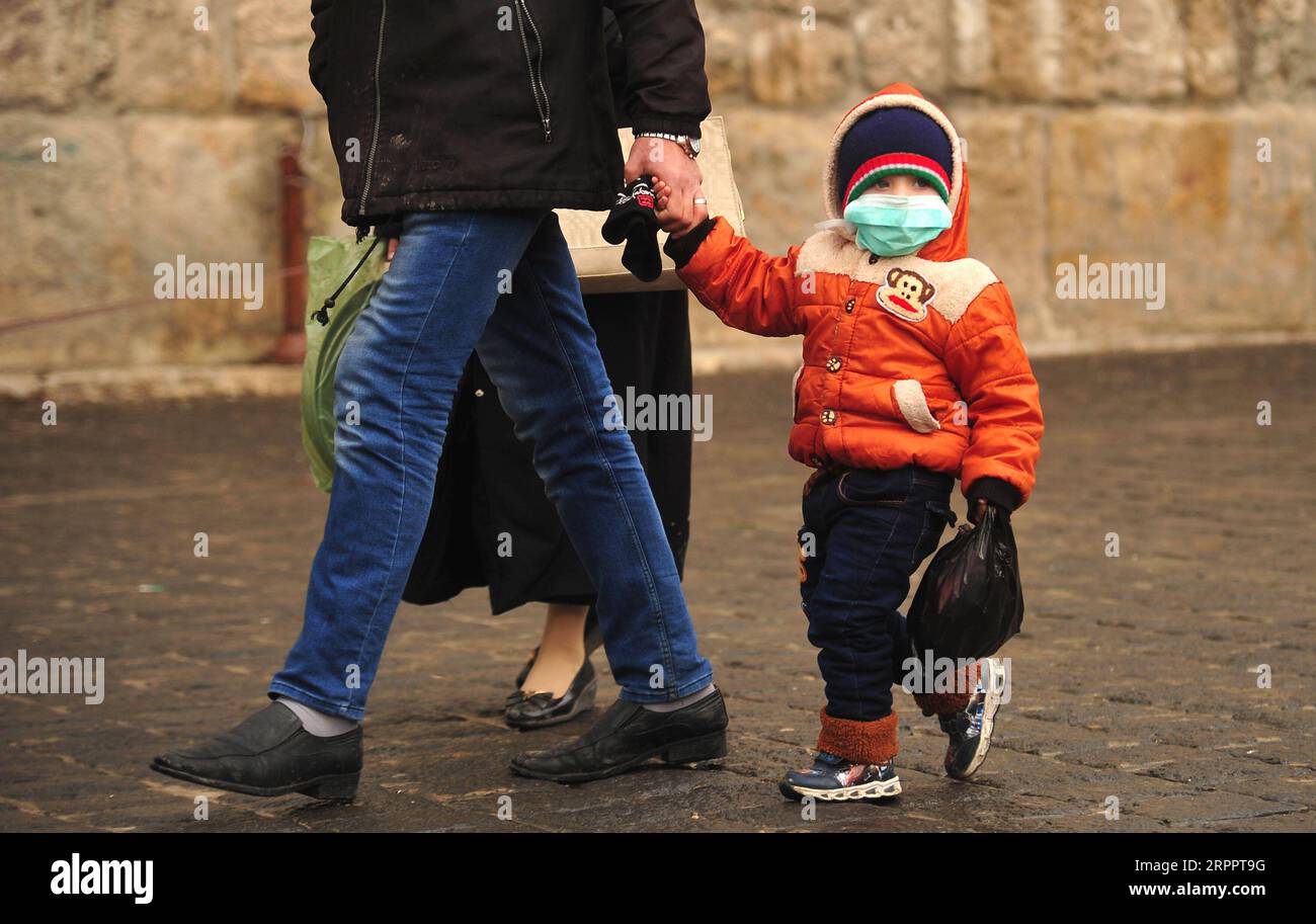 200322 -- DAMASCUS, March 22, 2020 -- A boy wearing a face mask is seen ...