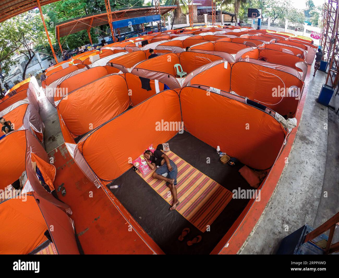200323 -- MANILA, March 23, 2020 -- A man sleeps in a modular tent set ...