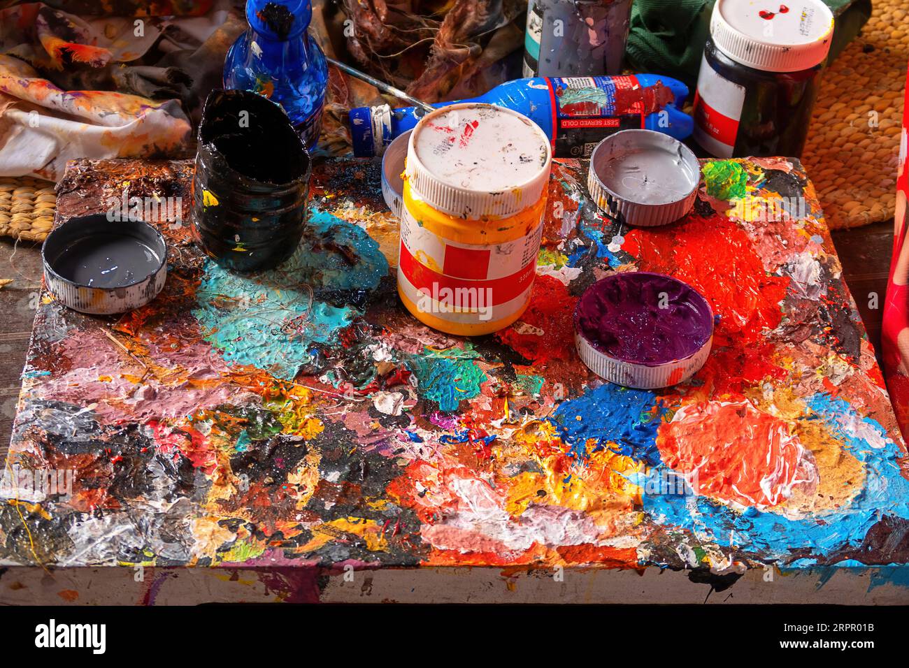 painters well used palette full of color and rough haphazard texture ...