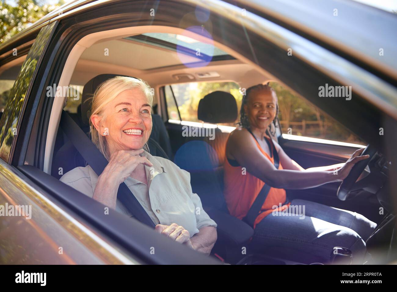 Two Senior Female Friends Enjoying Day Trip Out Driving In Car Together ...