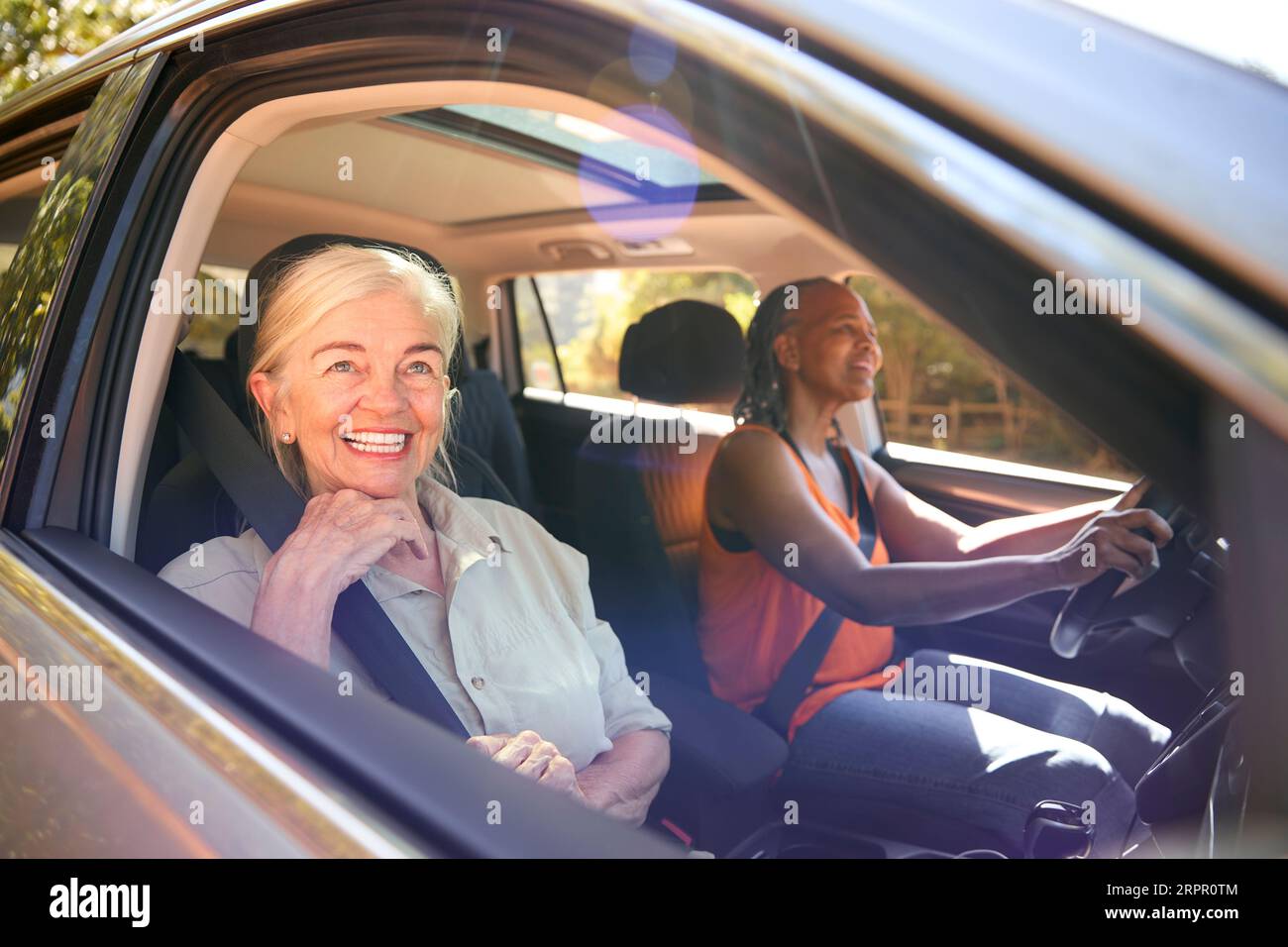 Two Senior Female Friends Enjoying Day Trip Out Driving In Car Together ...