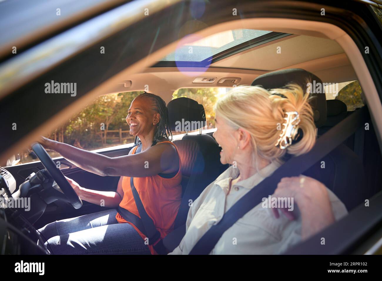 Two Senior Female Friends Enjoying Day Trip Out Driving In Car Together ...