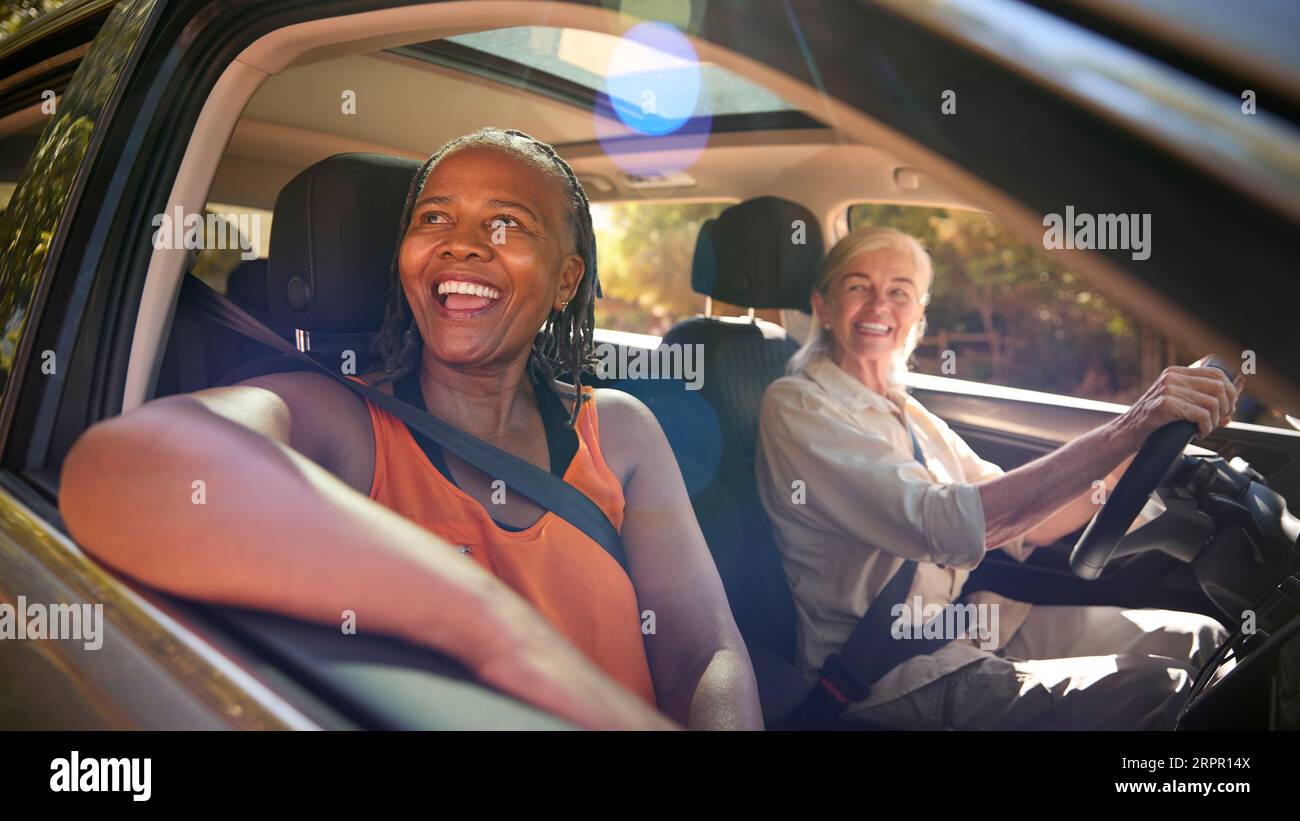 Two Senior Female Friends Enjoying Day Trip Out Driving In Car Together ...