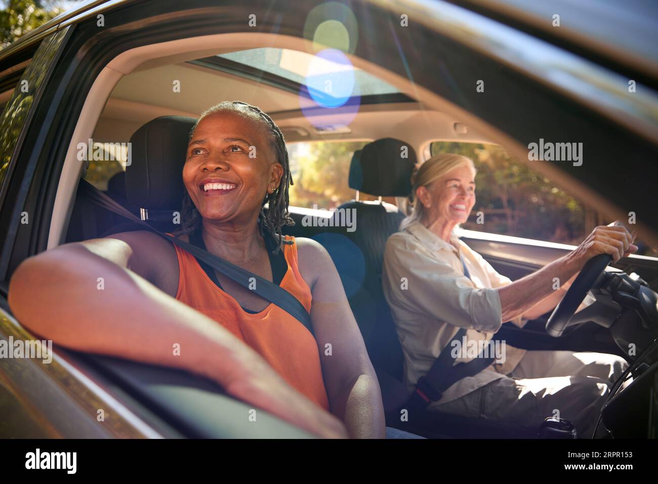 Two Senior Female Friends Enjoying Day Trip Out Driving In Car Together ...