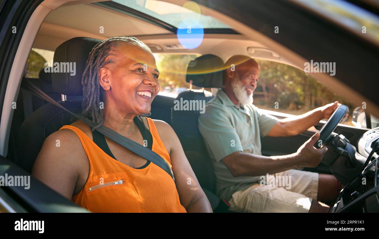 Senior Couple Enjoying Summer Day Trip Out Driving In Car Together ...