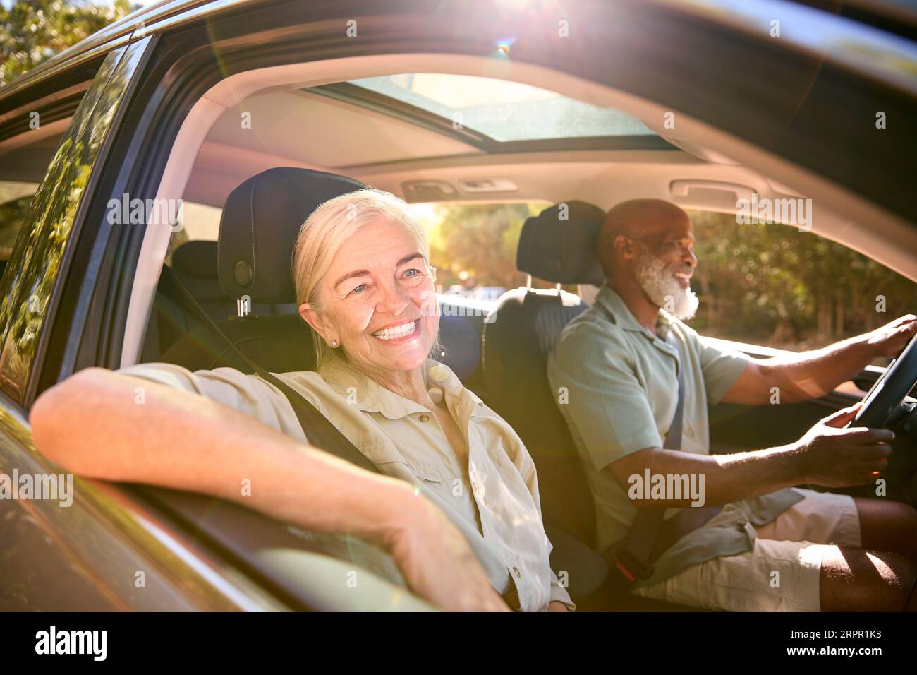 Senior Couple Enjoying Summer Day Trip Out Driving In Car Together ...