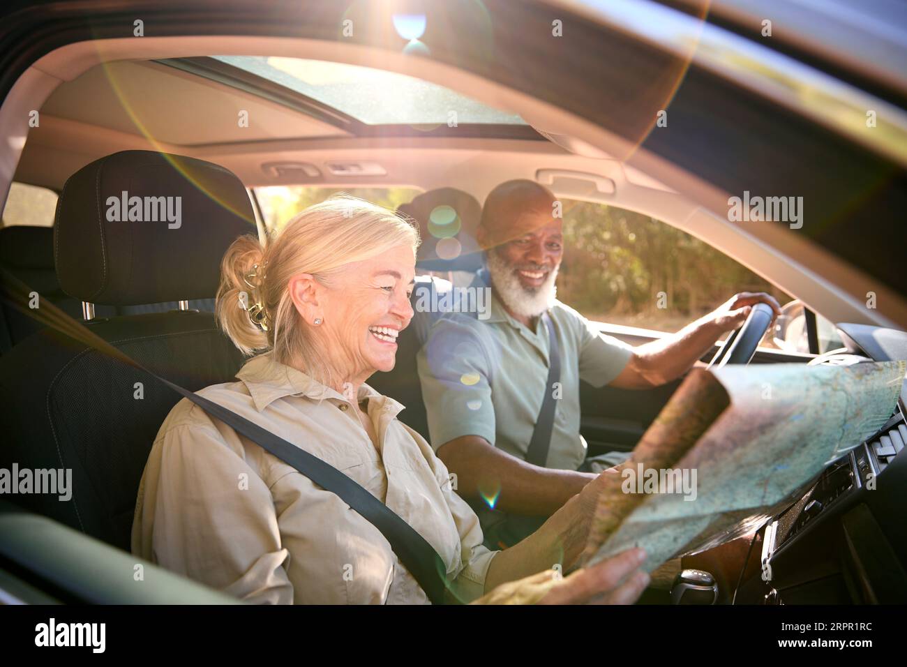 Senior Couple On Day Trip Out Driving In Car Reading Map Stock Photo ...