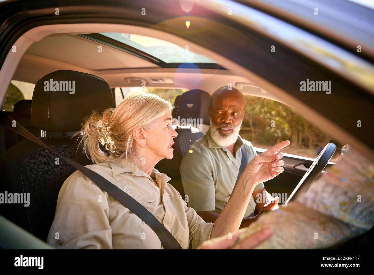 Confused Senior Couple On Day Trip Out Driving In Car Reading Map ...