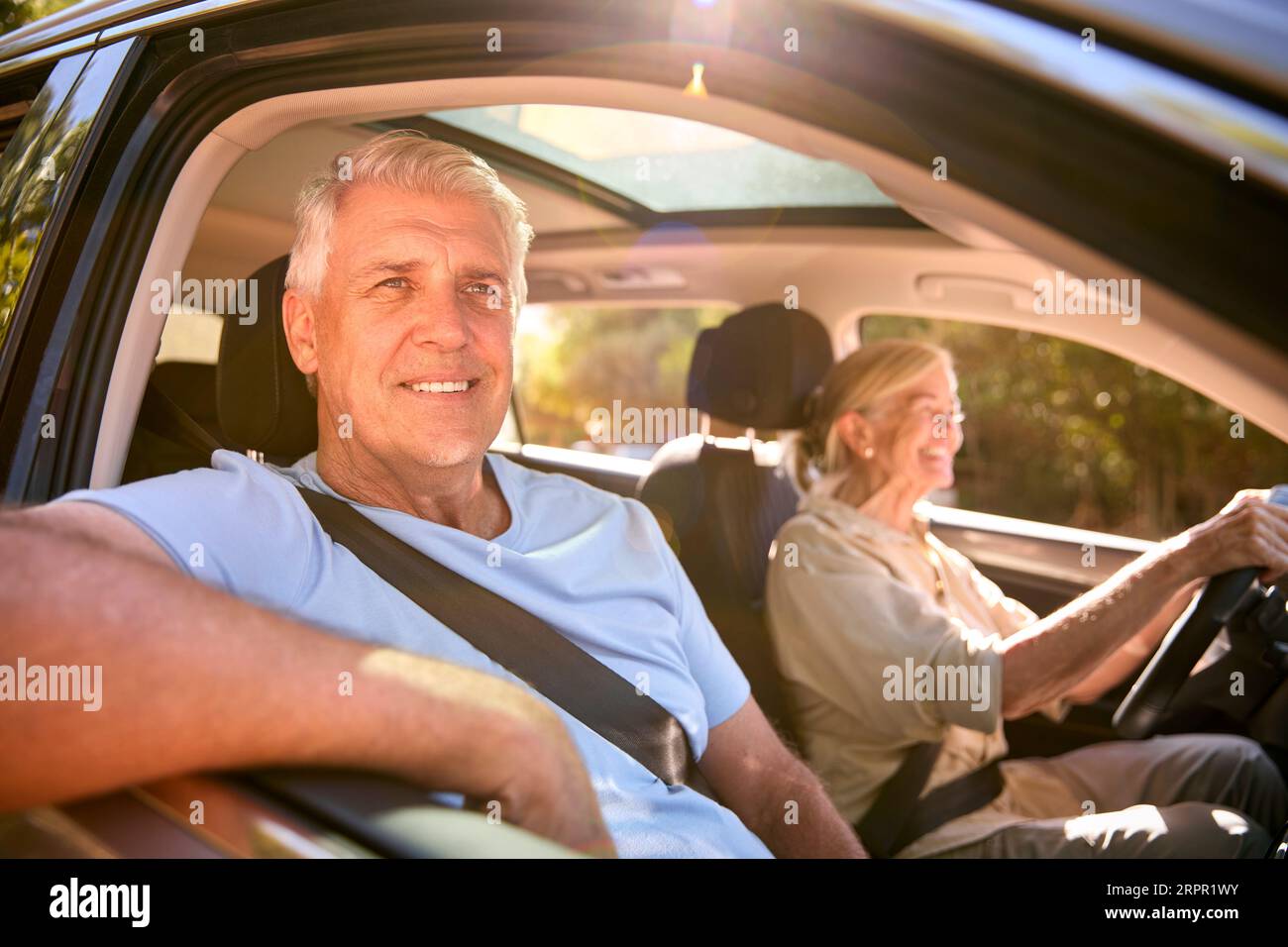 Senior Couple Enjoying Summer Day Trip Out Driving In Car Together ...