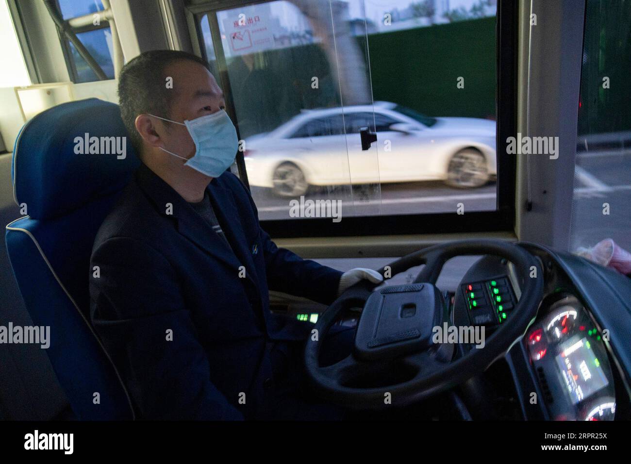 200325 -- WUHAN, March 25, 2020 -- A driver drives a bus in Wuhan ...
