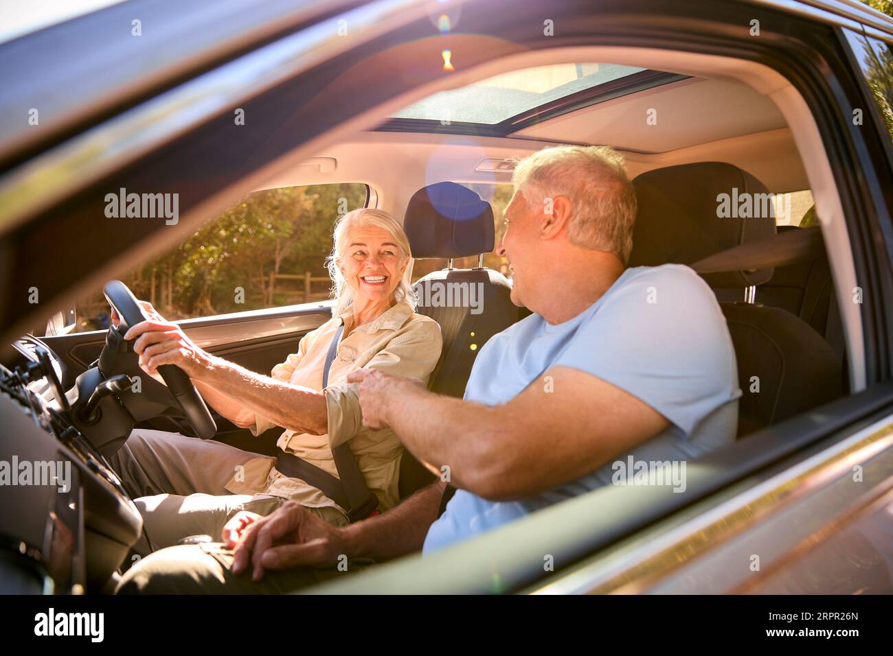 Senior Couple Enjoying Summer Day Trip Out Driving In Car Together ...