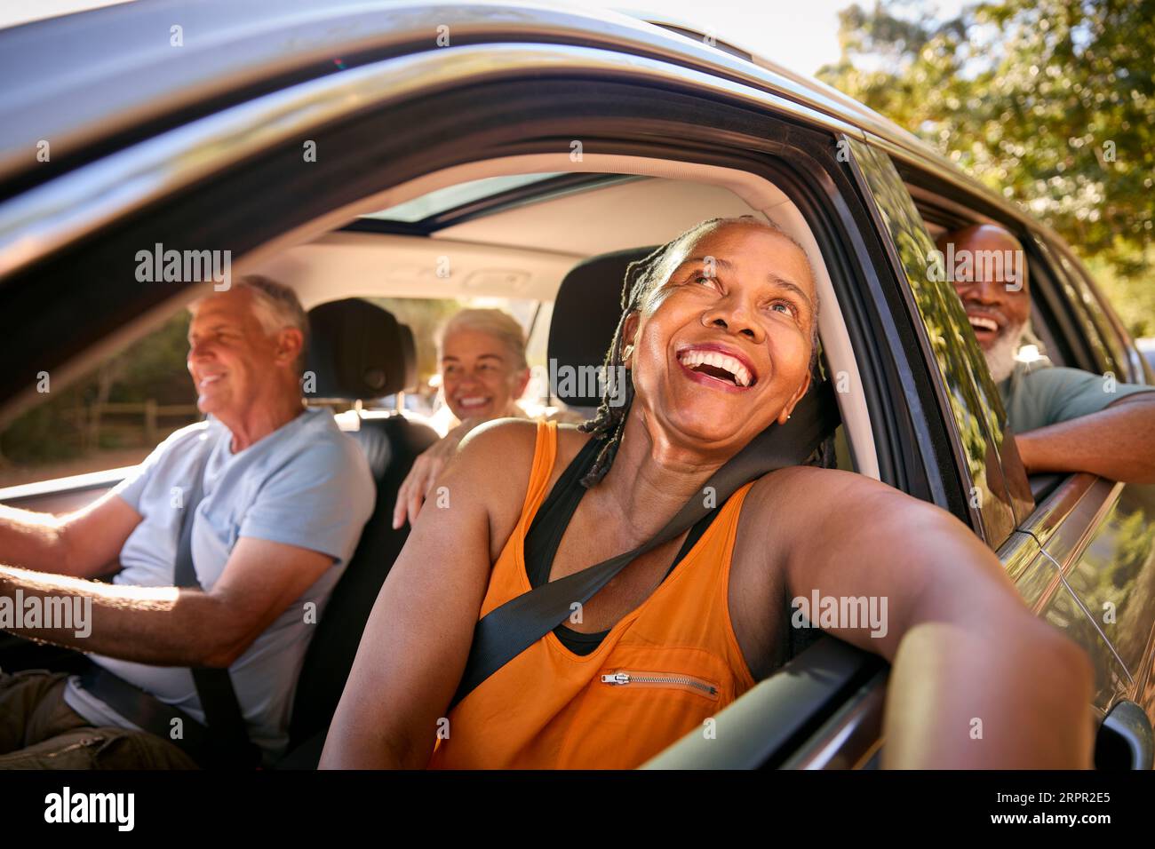 Group Of Senior Friends Enjoying Day Trip Out Driving In Car Together ...