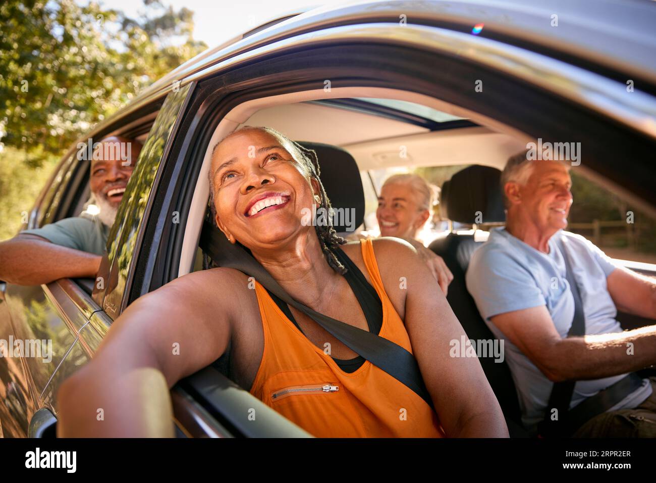Group Of Senior Friends Enjoying Day Trip Out Driving In Car Together ...