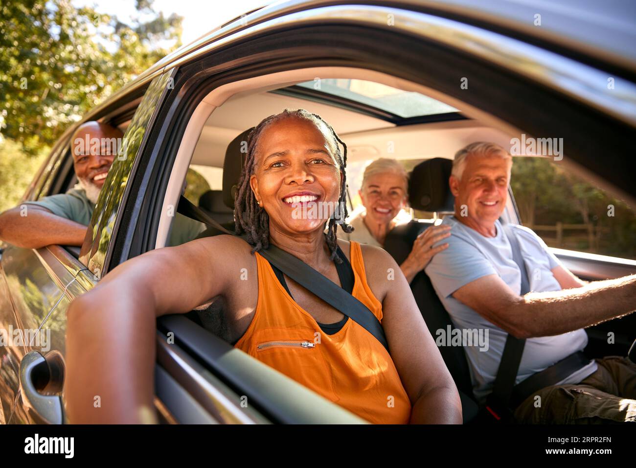 Portrait Of Group Of Senior Friends Enjoying Day Trip Out Driving In ...