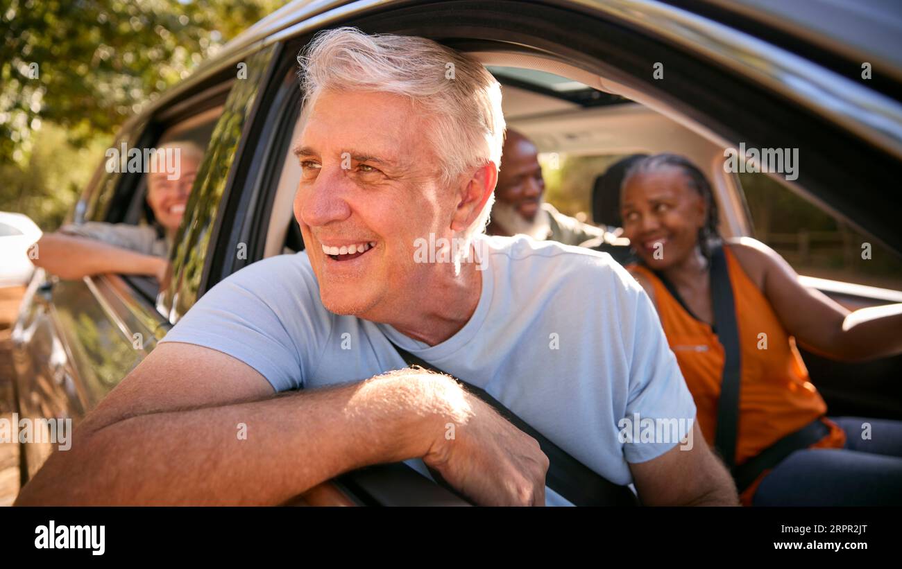 Group Of Senior Friends Enjoying Day Trip Out Driving In Car Together ...