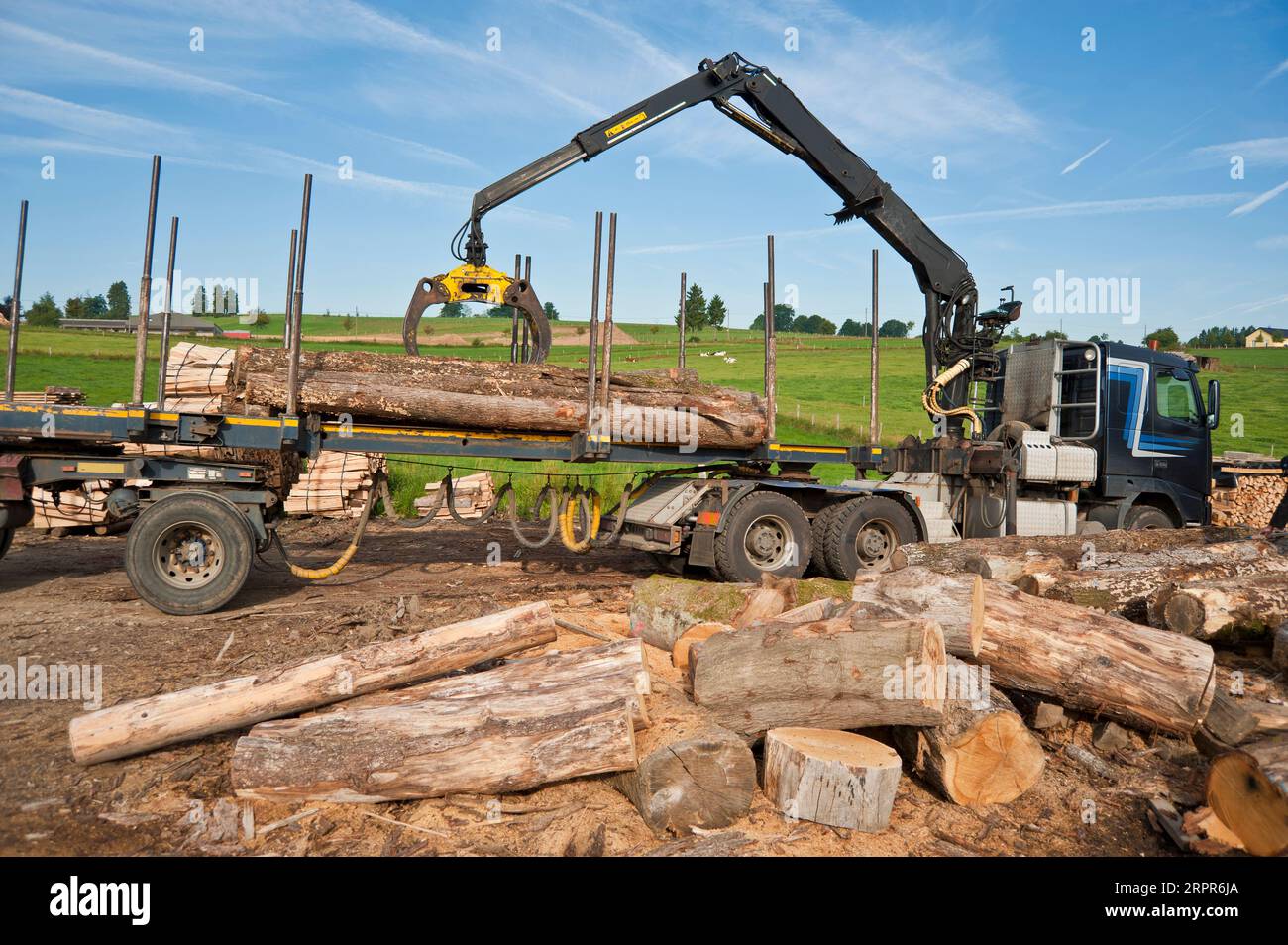 loading firewood with the truck crane Stock Photo - Alamy