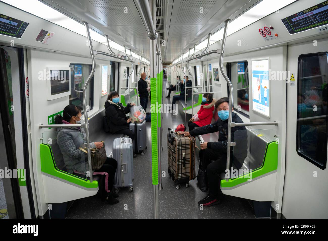 200328 -- WUHAN, March 28, 2020 -- Passengers sit apart on a train of ...