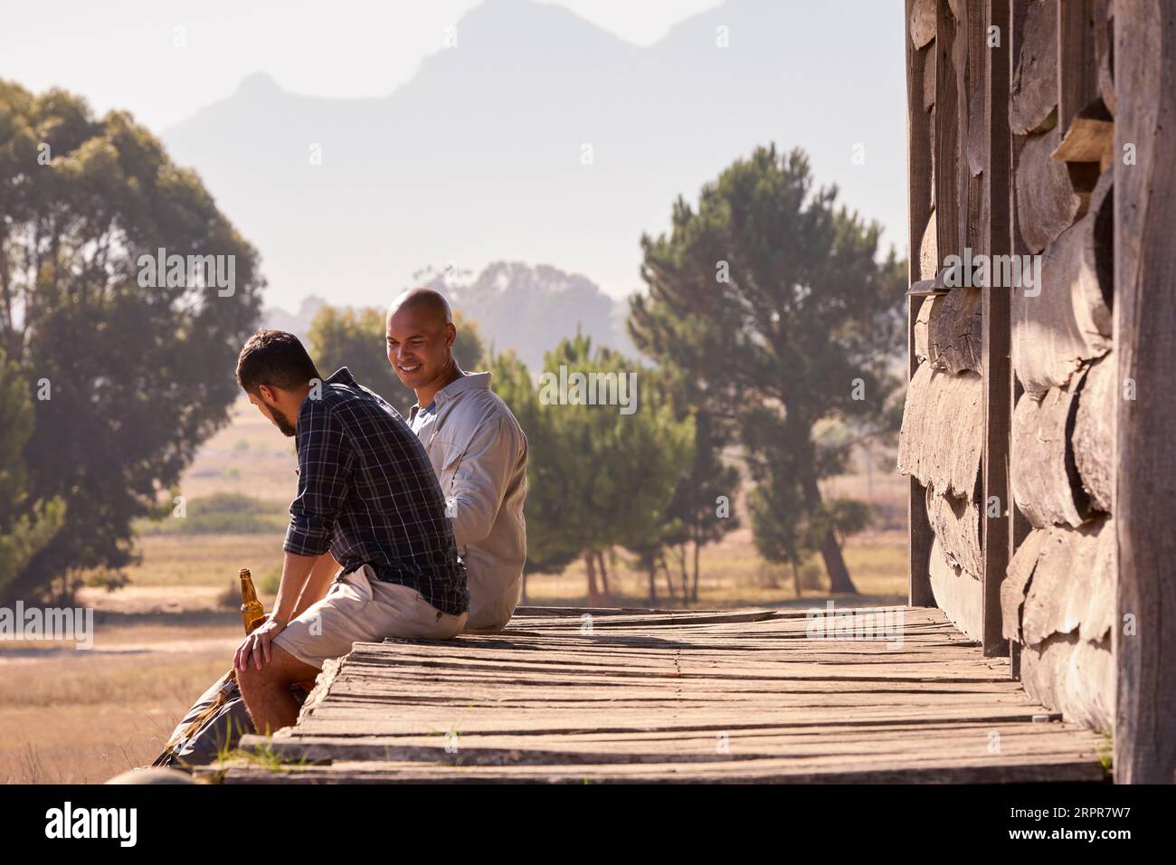 Friends drinking beer on porch hi-res stock photography and images - Alamy