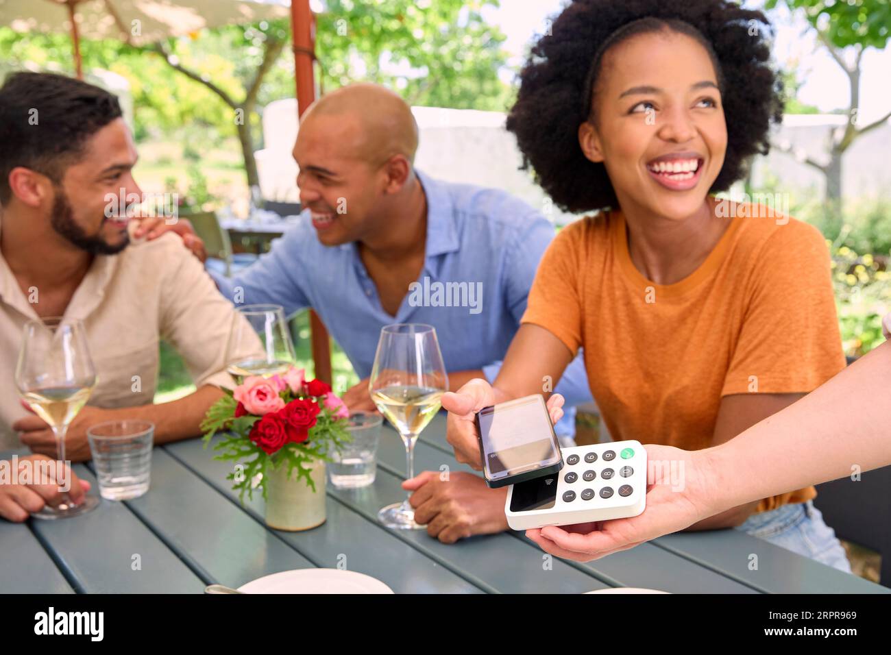 Woman Paying Bill At Outdoor Bar Or Restaurant Using Contactless App On ...