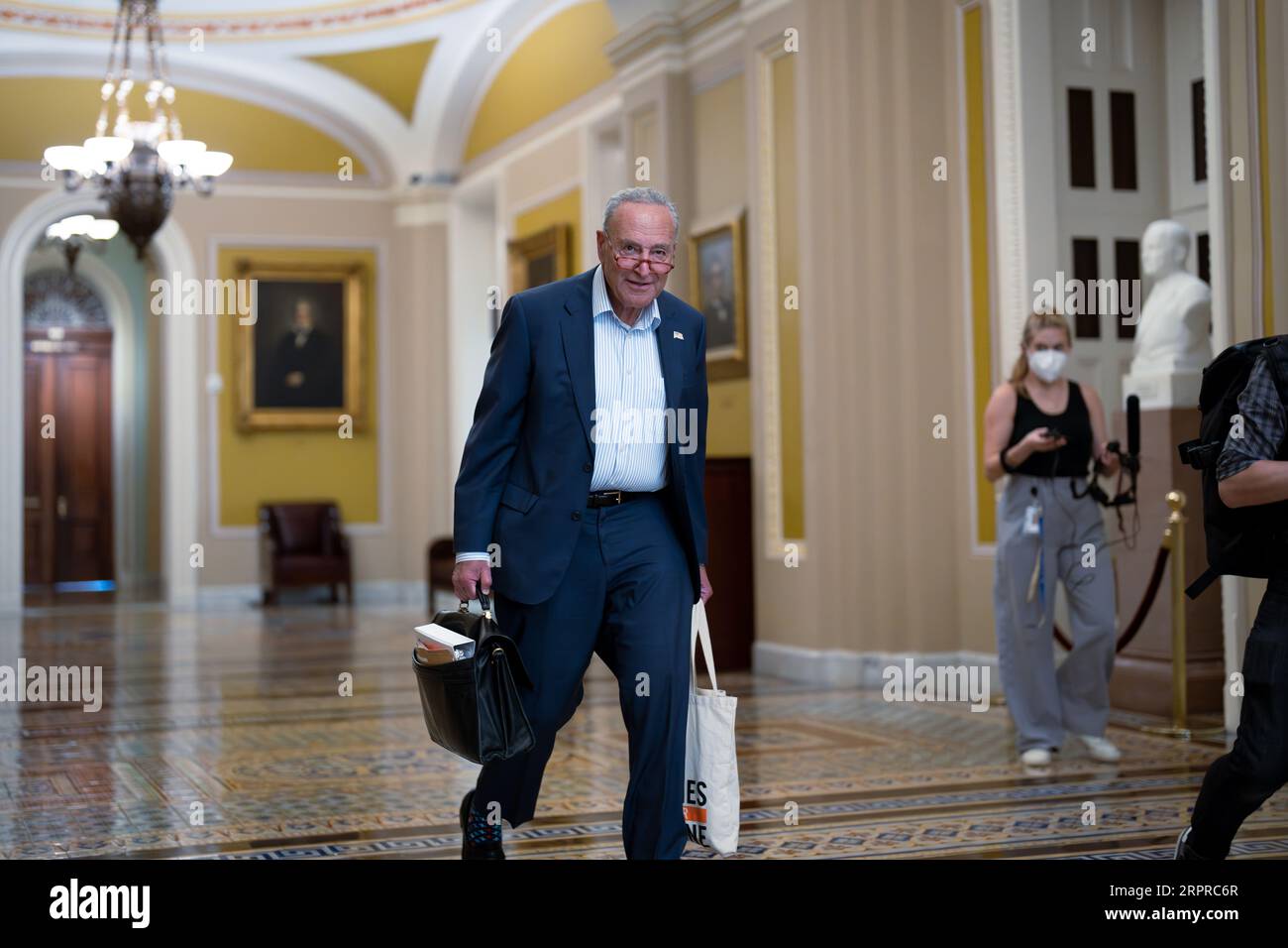 Senate Majority Leader Chuck Schumer, D-N.Y., carries his bags as the ...