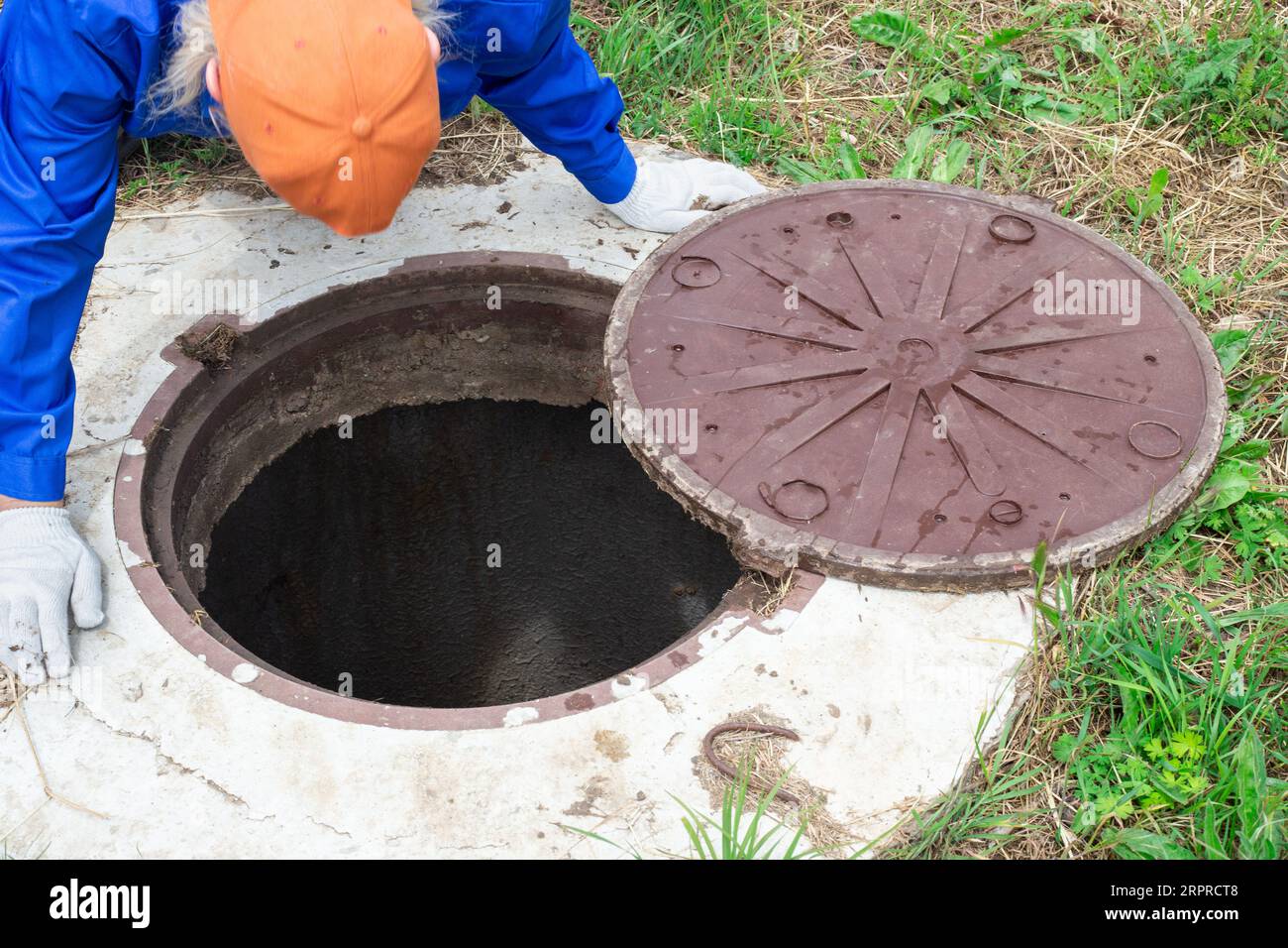 the plumber leaned over the concrete well. Control and maintenance of ...