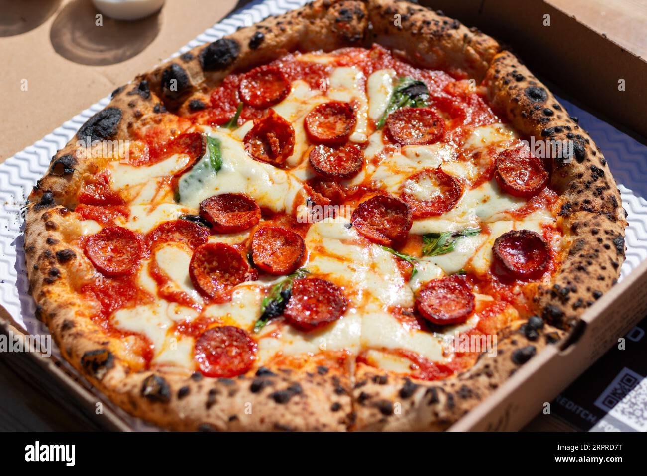 Neapolitan homemade pizza margarita with pepperoni from the brick oven ...