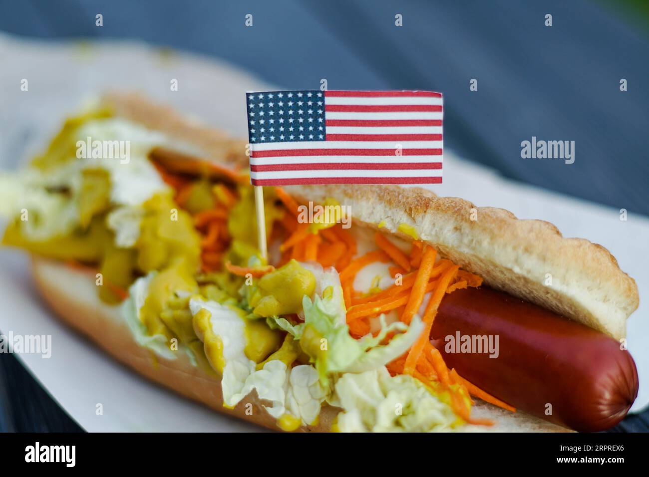 Hot dogs with mustard and small flag of United States of America ...