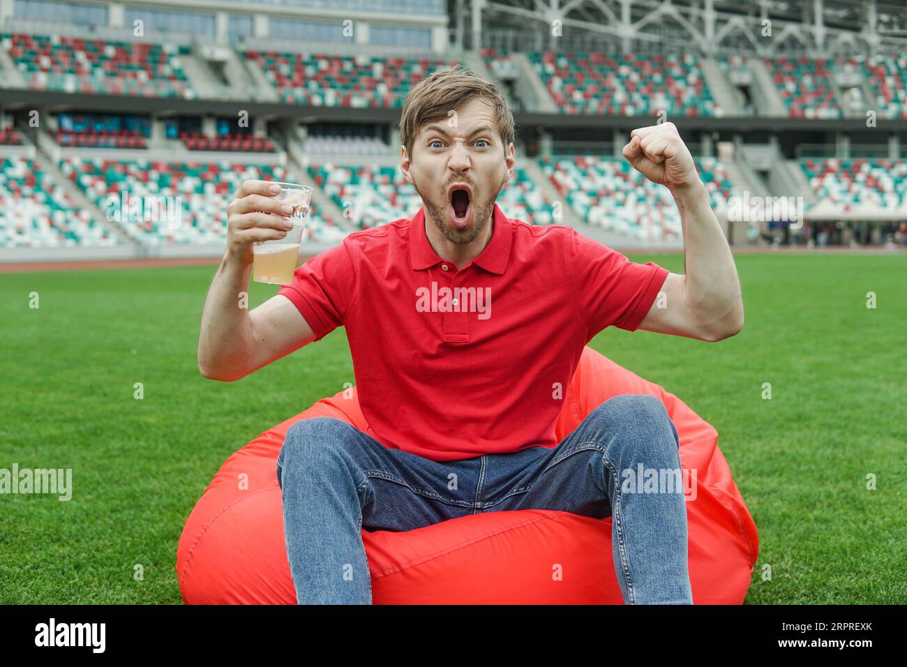 Soccer fan with glass of beer support his football team and celebrate ...