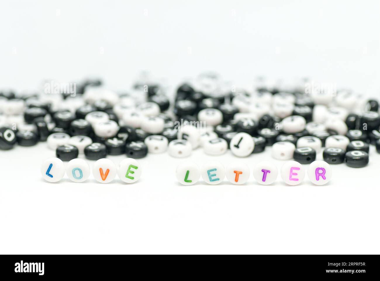 black and white round letters and love letter written with colored ...