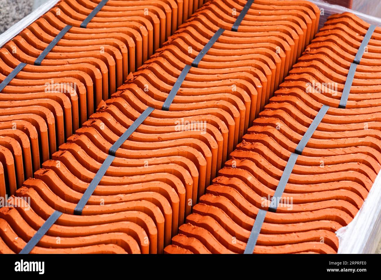Packed in rows new red brown roof fired ceramic clay tiles, delivered ...