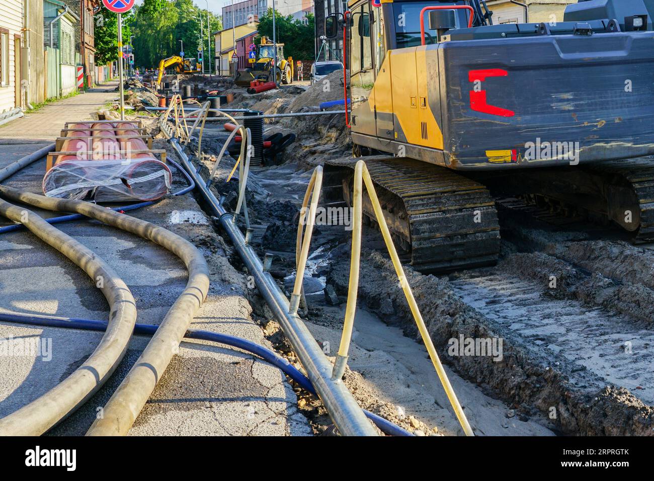 Street reconstruction view, deep and wide trench, replaced underground pipes and wells, new ...