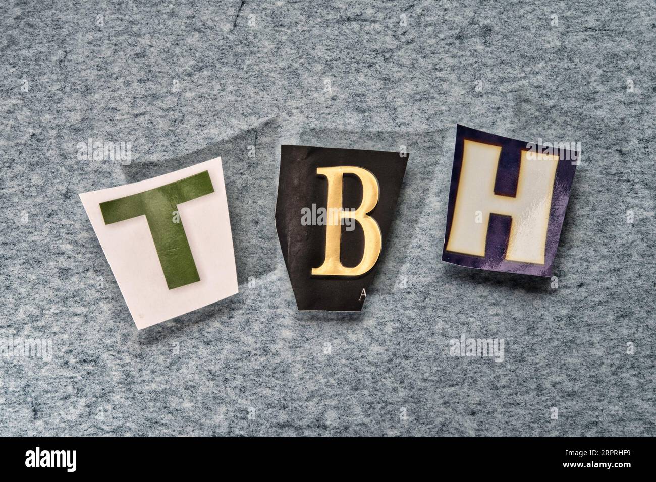 The acronym "TBH" (To Be Honest) using cut-out paper letters in the ...